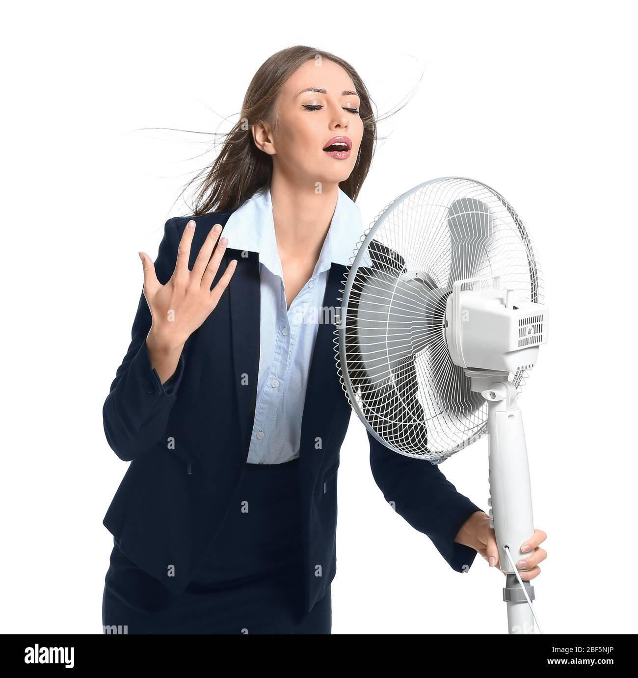 Young woman with electric fan on white background Stock Photo - Alamy