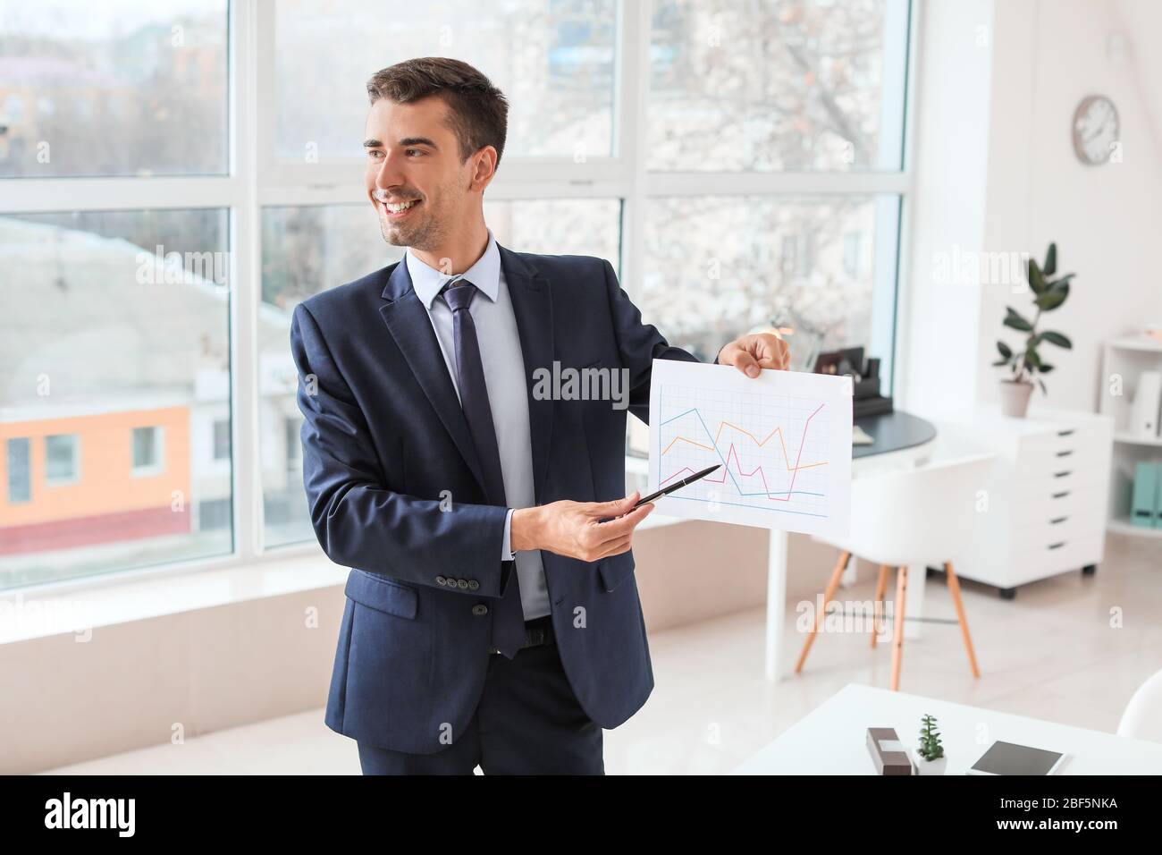 Male bank manager working in office Stock Photo - Alamy