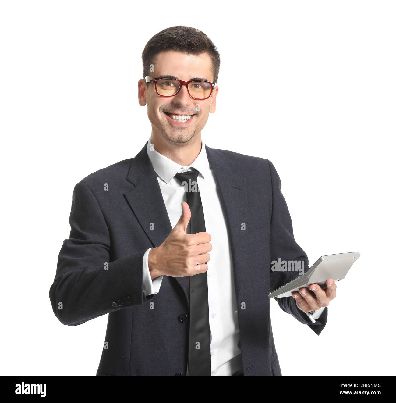 Happy male bank manager with calculator showing thumb-up gesture on ...
