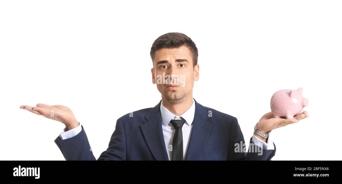 Sad male bank manager with piggy bank on white background Stock Photo ...