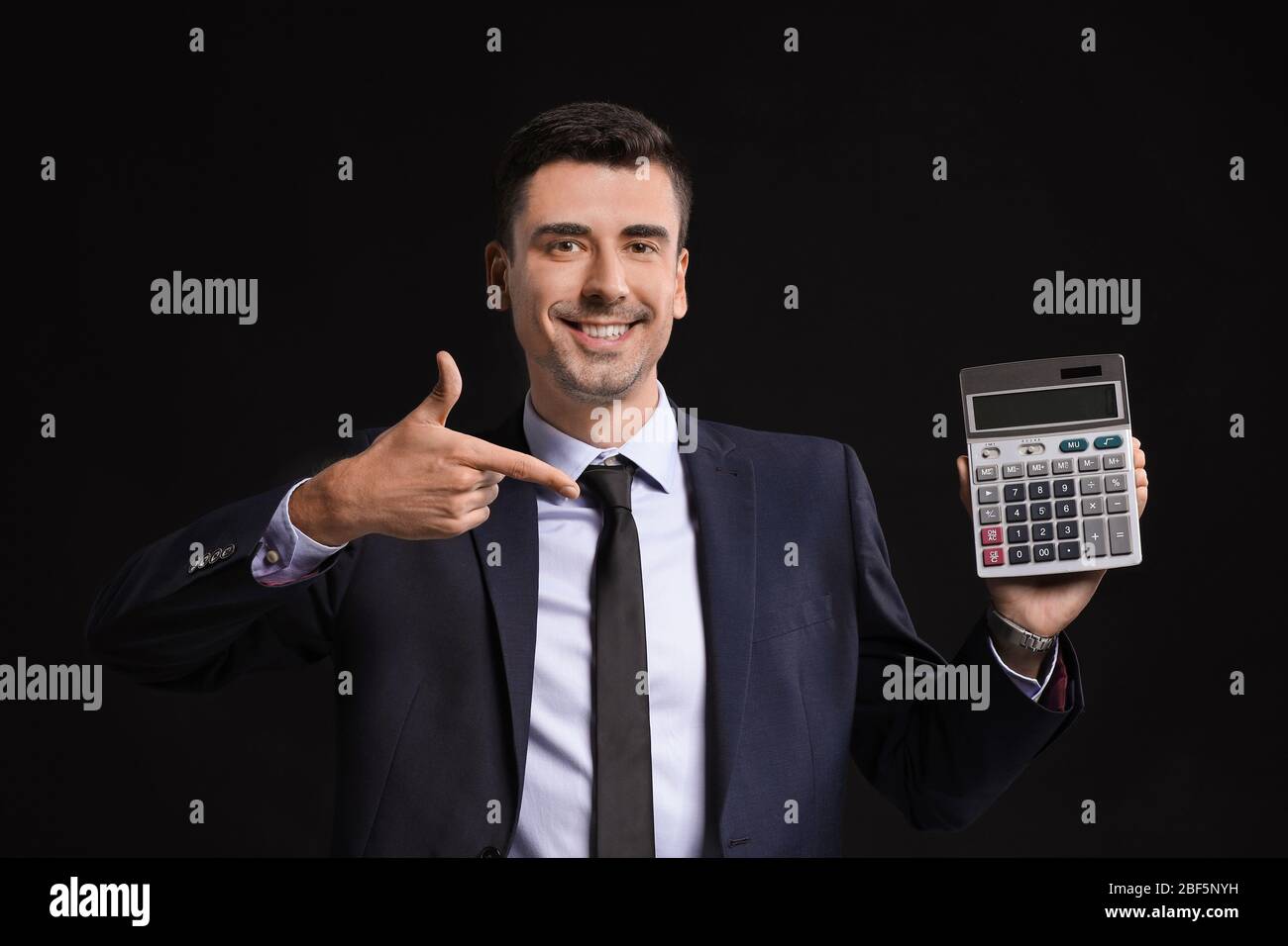 Bank employee showing calculator hi-res stock photography and images ...