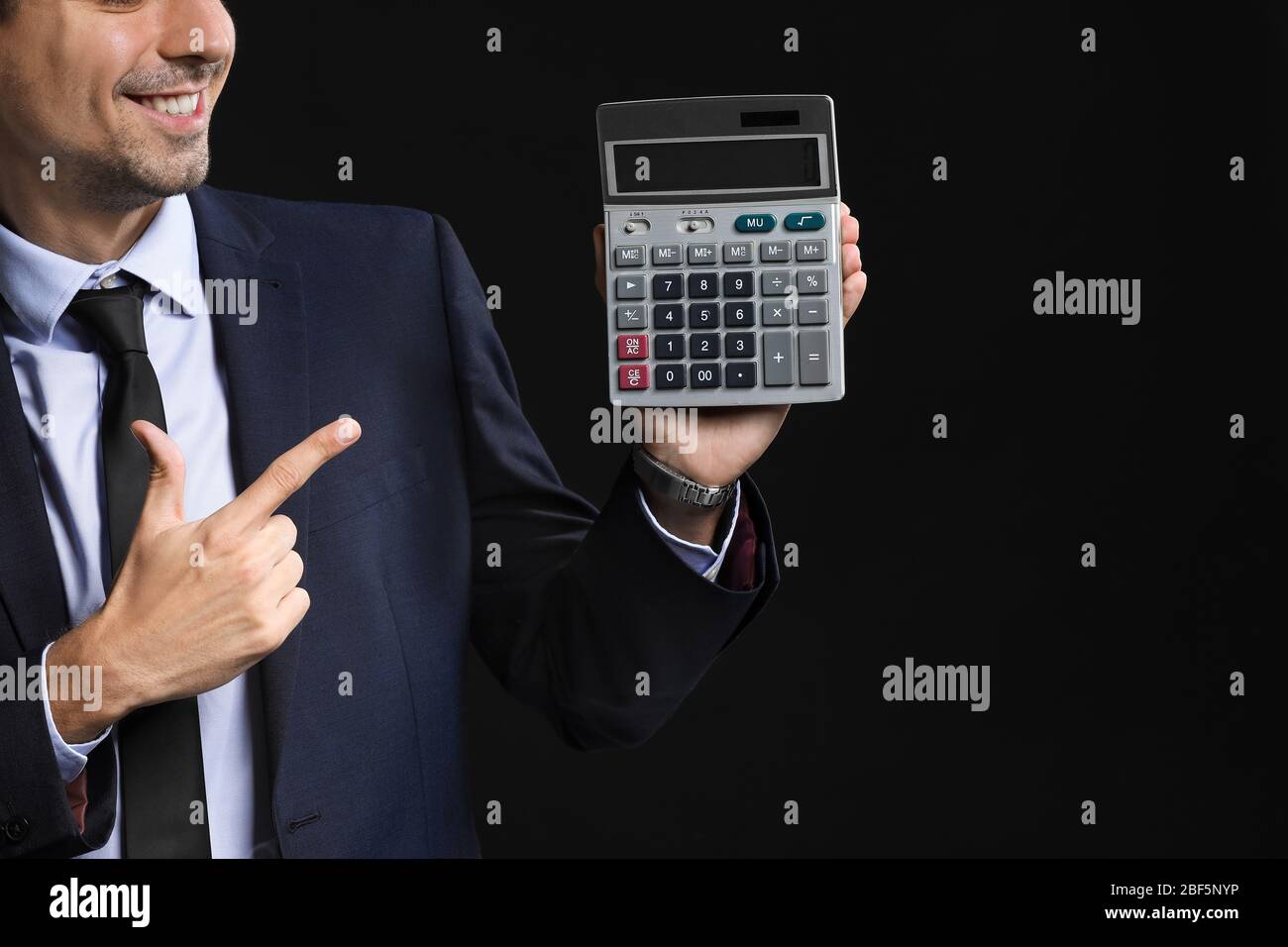 Bank employee showing calculator hi-res stock photography and images ...