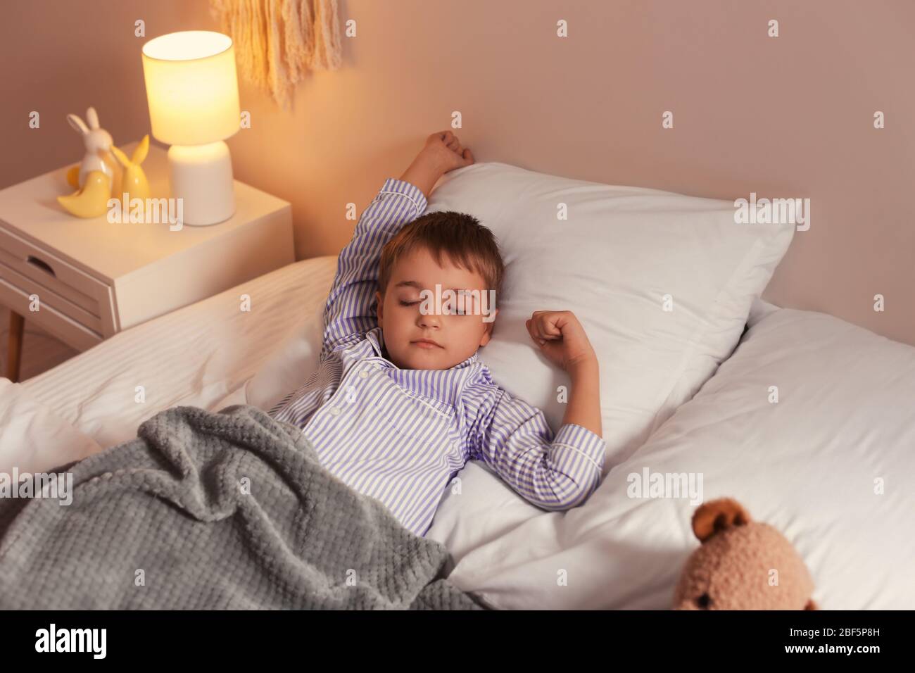 Cute little boy sleeping in bed Stock Photo - Alamy