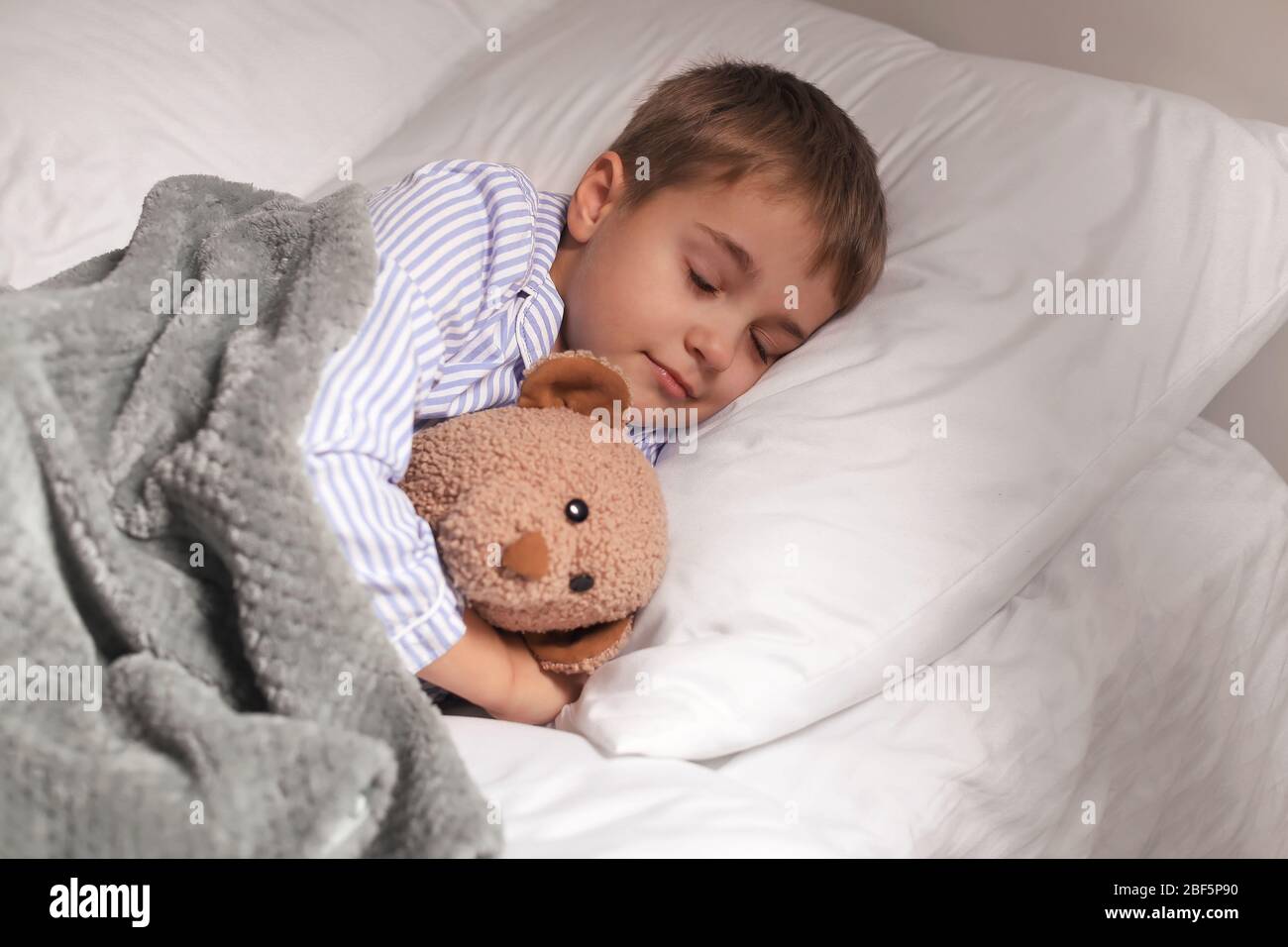 Cute little boy sleeping in bed Stock Photo - Alamy