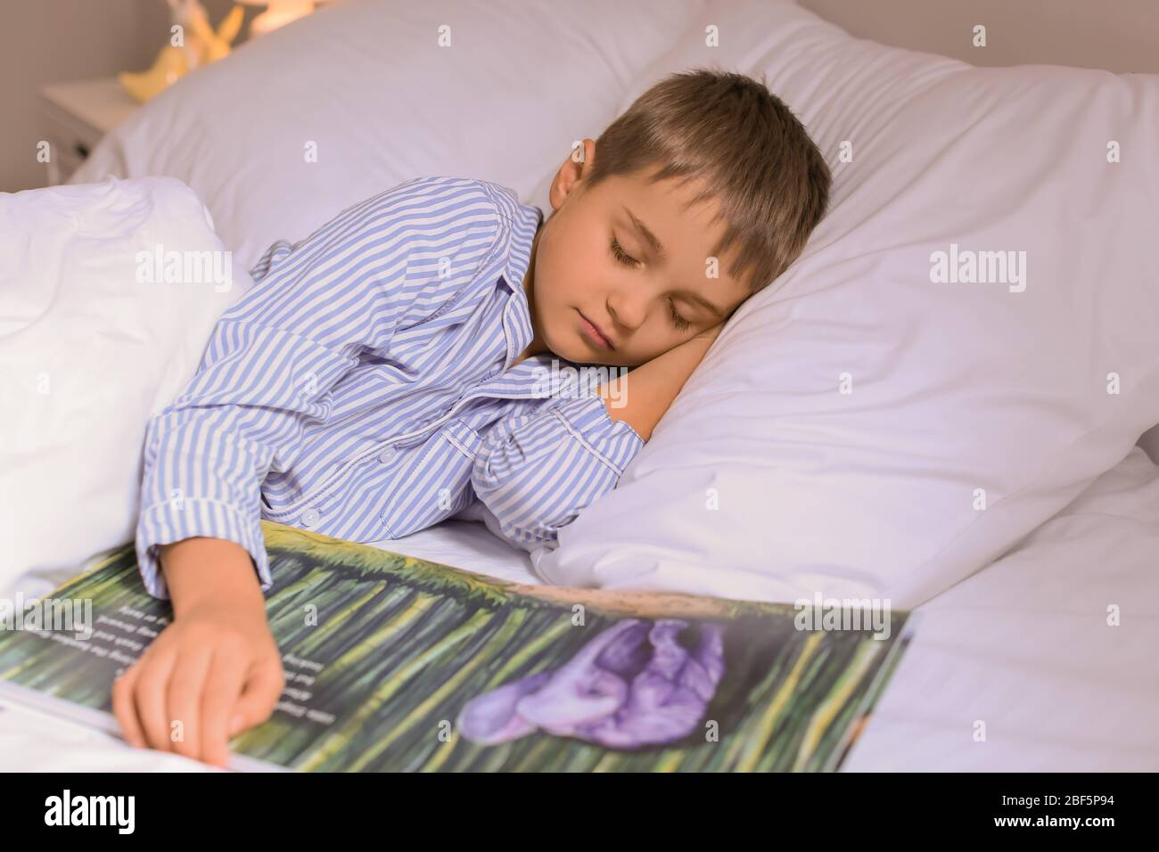 Cute little boy sleeping in bed at night Stock Photo - Alamy