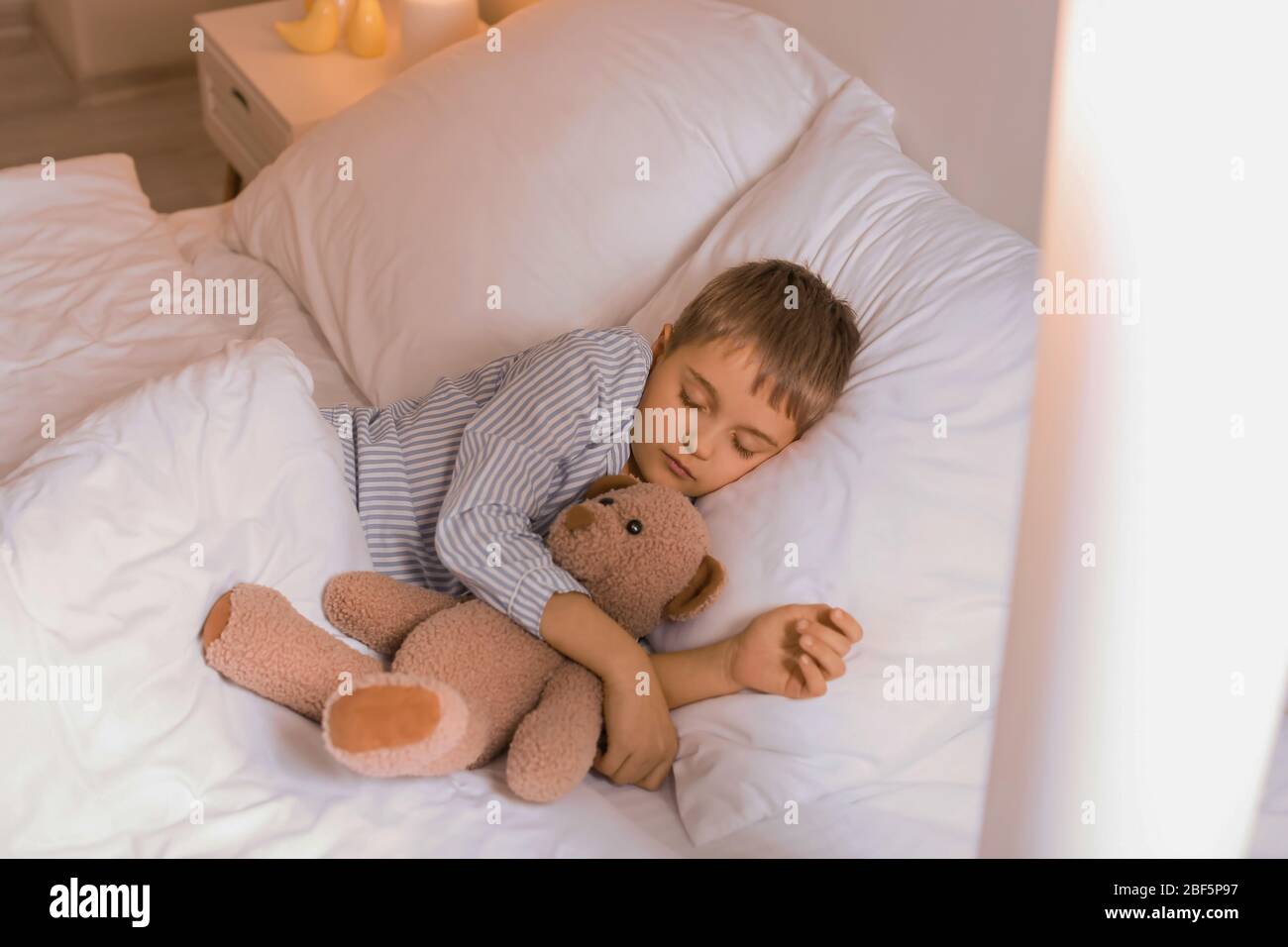 Cute little boy sleeping in bed at night Stock Photo - Alamy