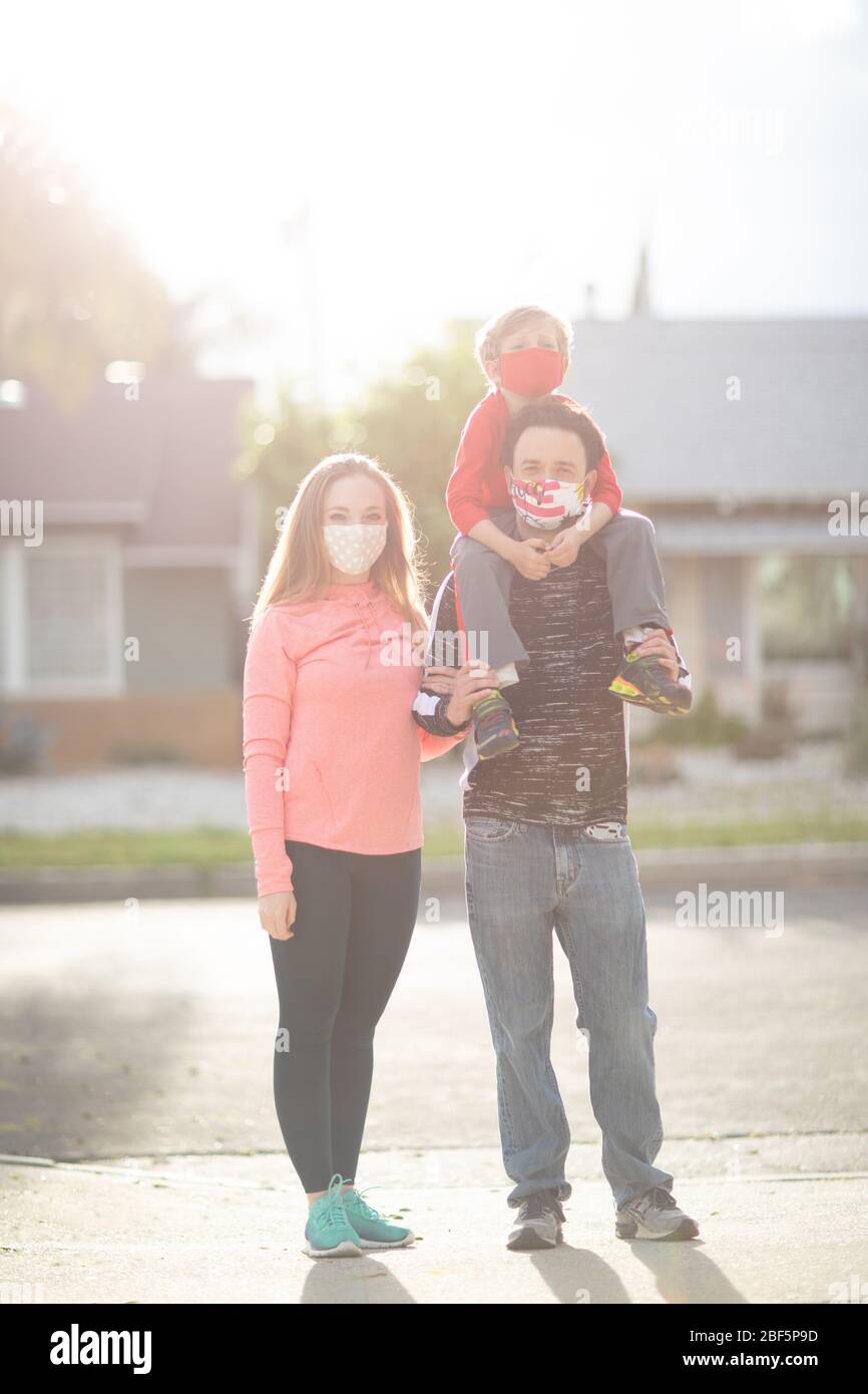 Family members embracing each other, standing in front of the house ...