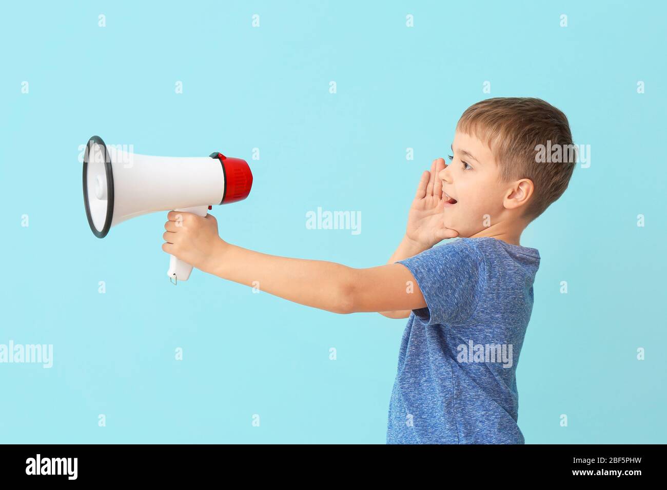 Cute little boy with megaphone on color background Stock Photo - Alamy