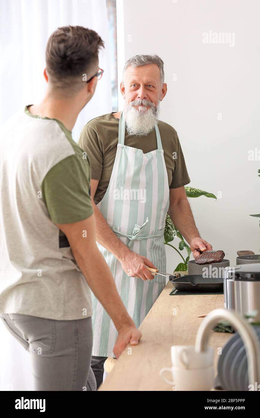 Senior man care home prepare food hi-res stock photography and images ...