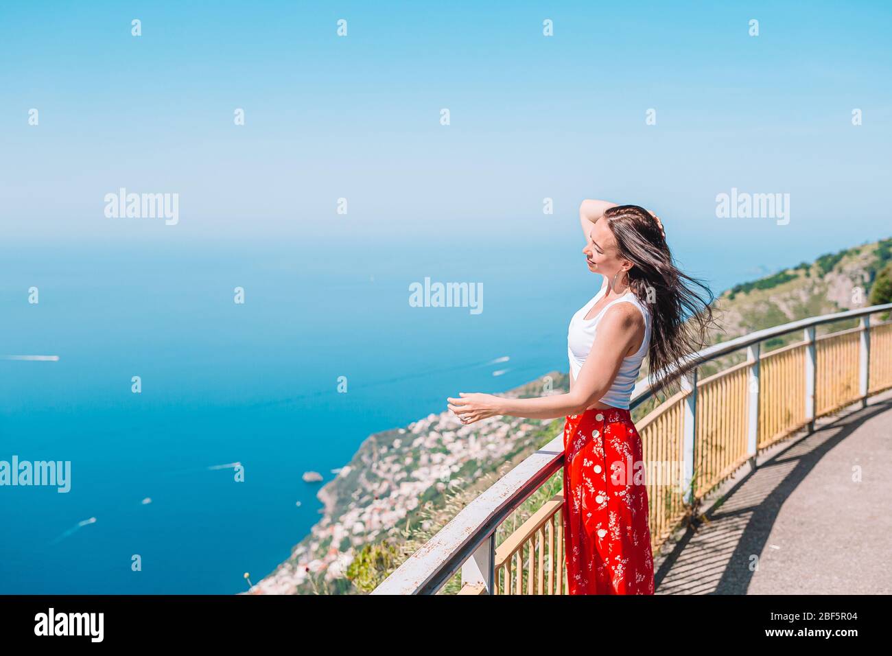 Summer holiday in Italy. Young woman in village on the background ...