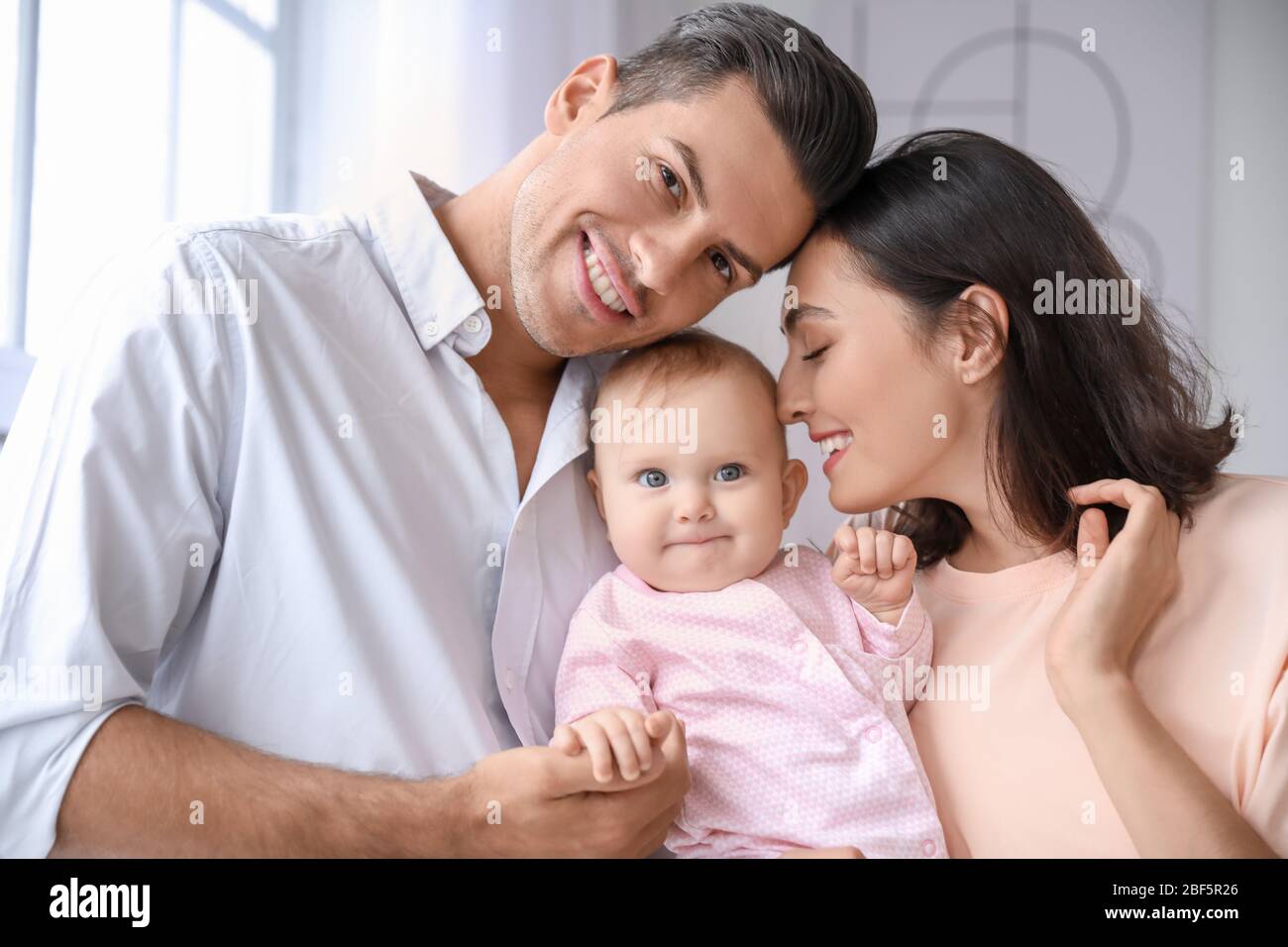 Cute baby with parents at home Stock Photo - Alamy