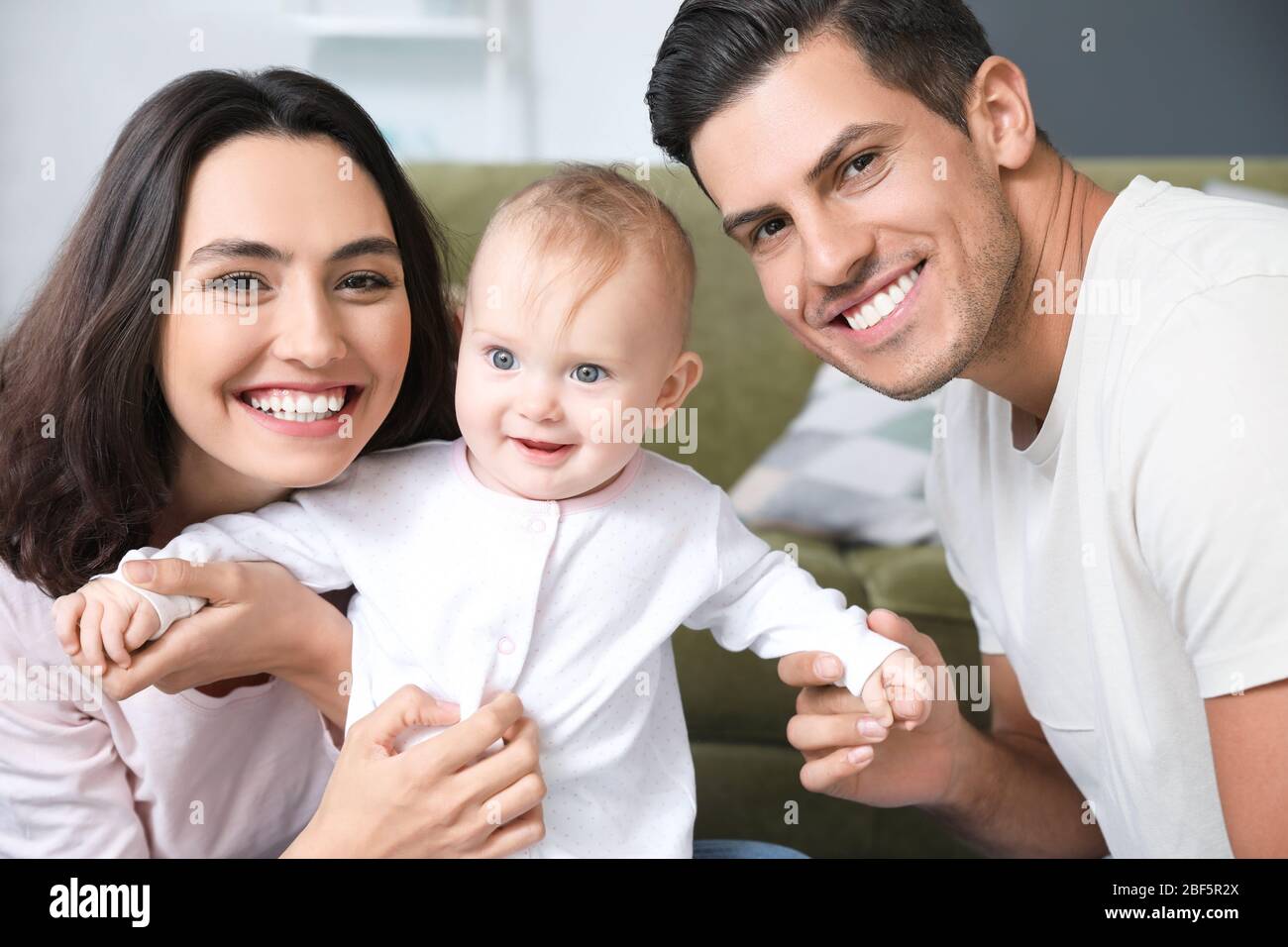 Cute baby with parents at home Stock Photo - Alamy