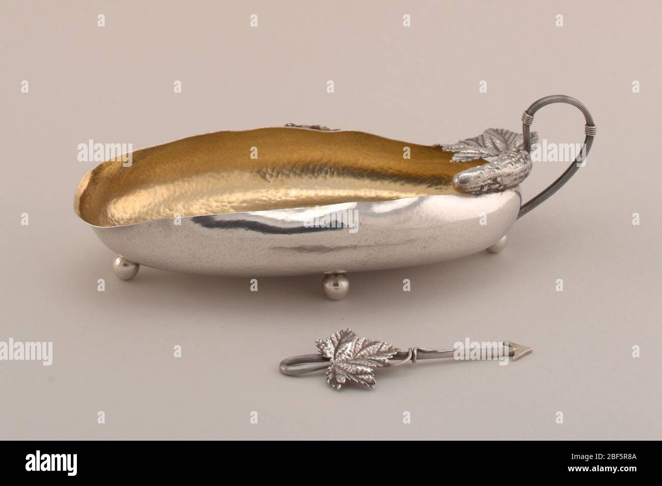 Pickle dish and spear. In the form of a cucumber pickle, with gilt ...
