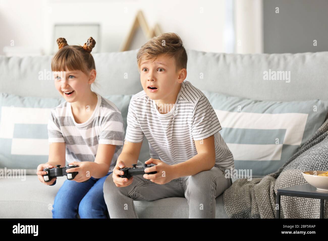 Little children playing video games at home Stock Photo - Alamy