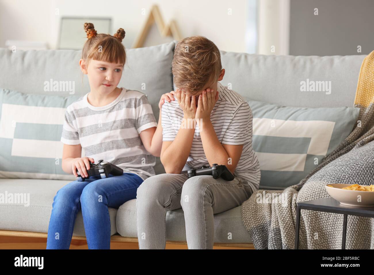 Little children playing video games at home Stock Photo - Alamy