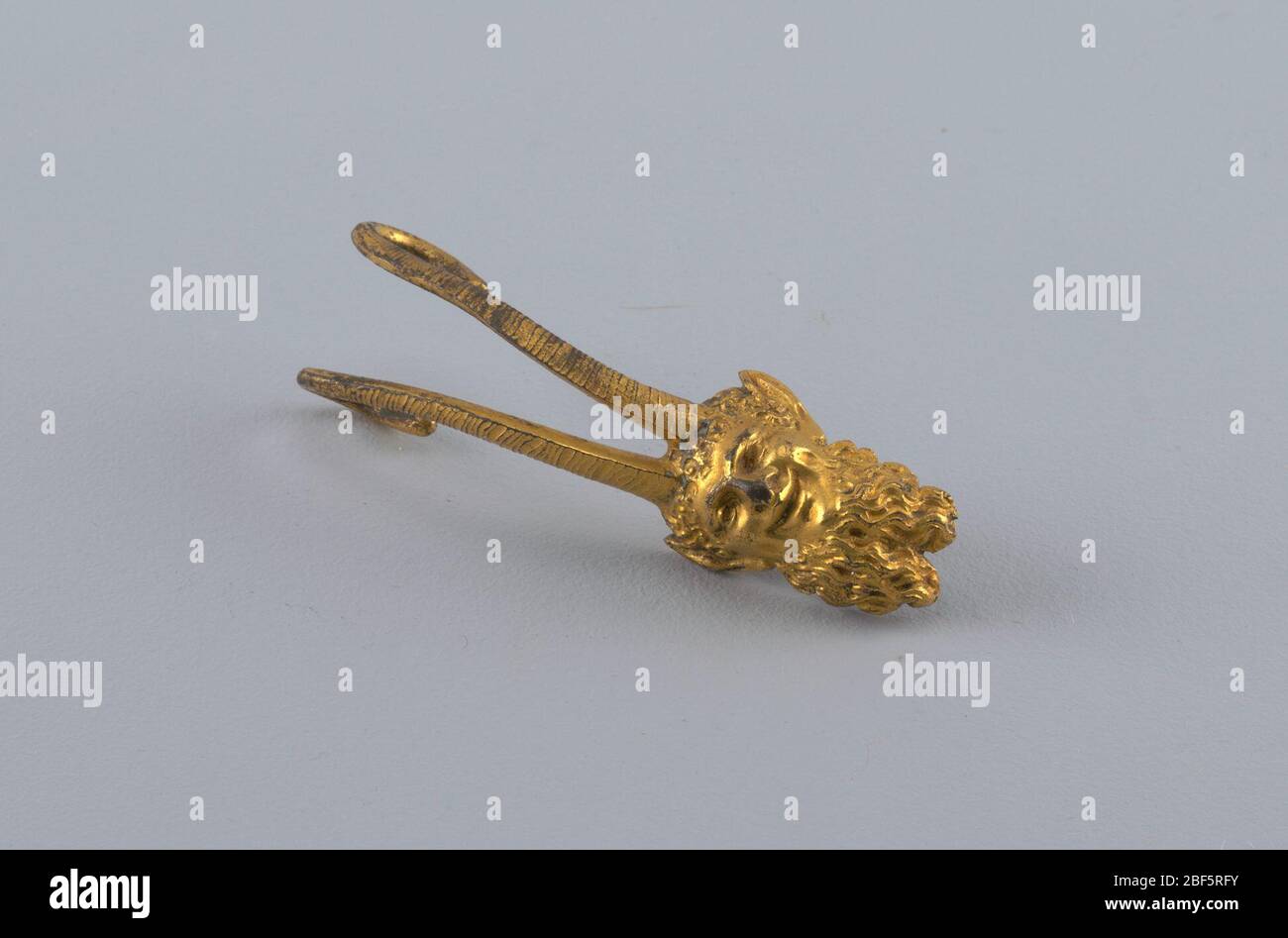 Mount. Head of a bearded satyr with long horns Stock Photo - Alamy