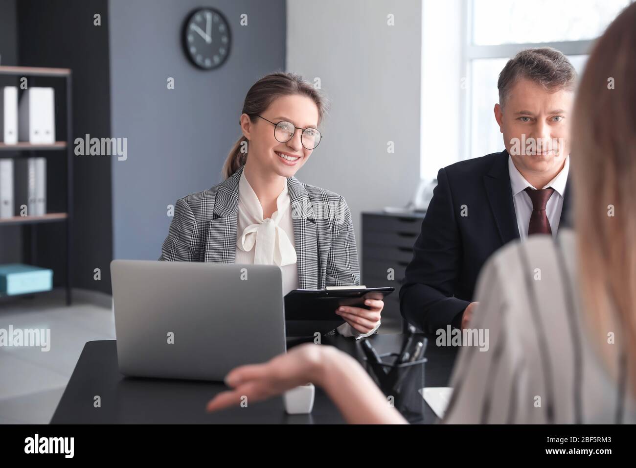 Human resources commission interviewing woman in office Stock Photo - Alamy