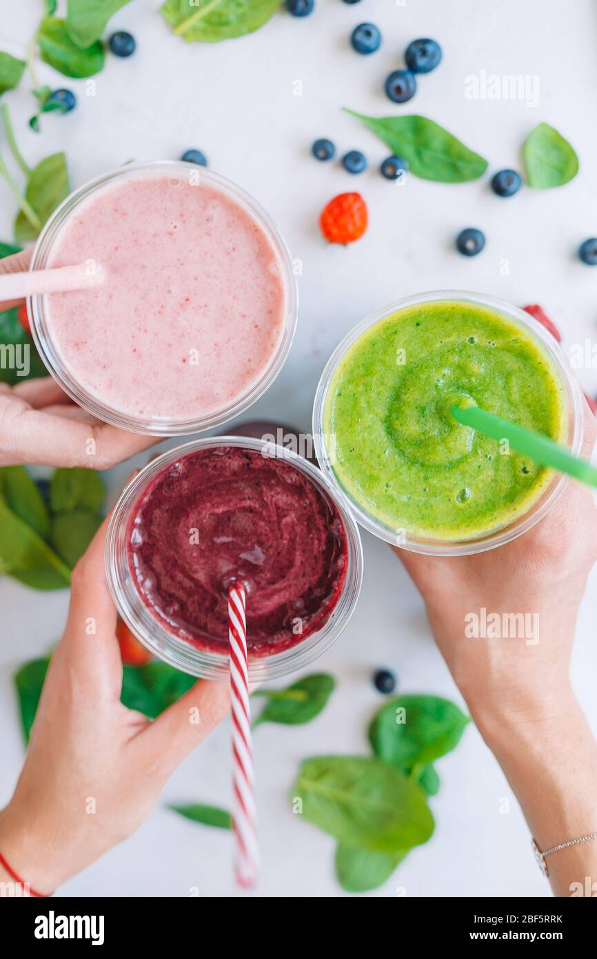 Row of healthy fresh fruit and vegetable smoothies with assorted ...