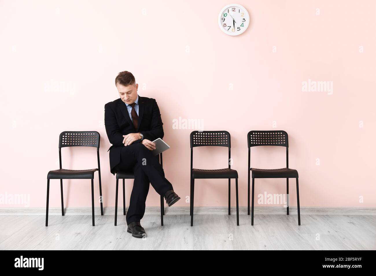 Mature man waiting for job interview indoors Stock Photo - Alamy