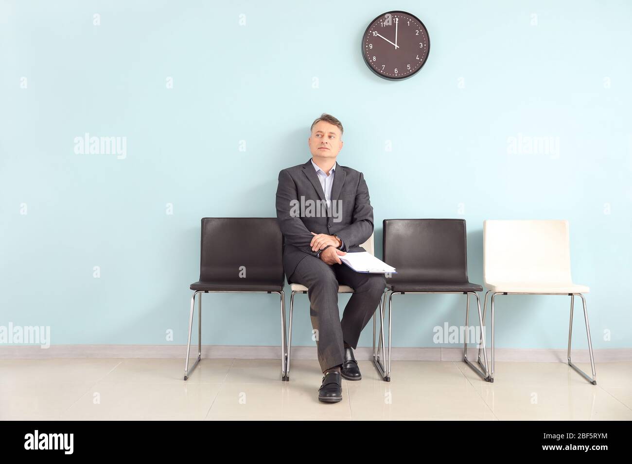 Mature man waiting for job interview indoors Stock Photo - Alamy