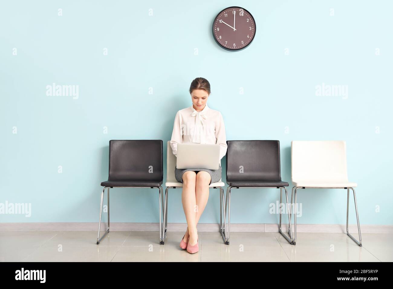 Young woman waiting for job interview indoors Stock Photo - Alamy