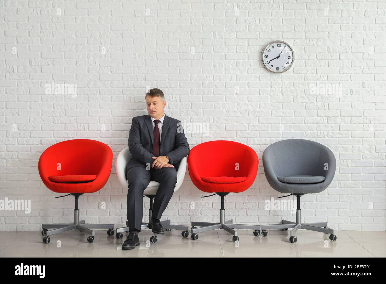 Mature man waiting for job interview indoors Stock Photo - Alamy