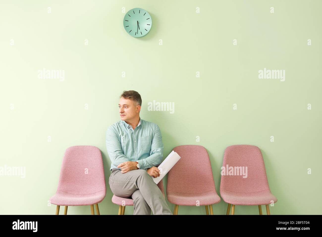 Mature man waiting for job interview indoors Stock Photo - Alamy