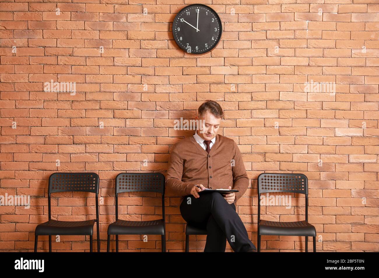 Mature man waiting for job interview indoors Stock Photo - Alamy
