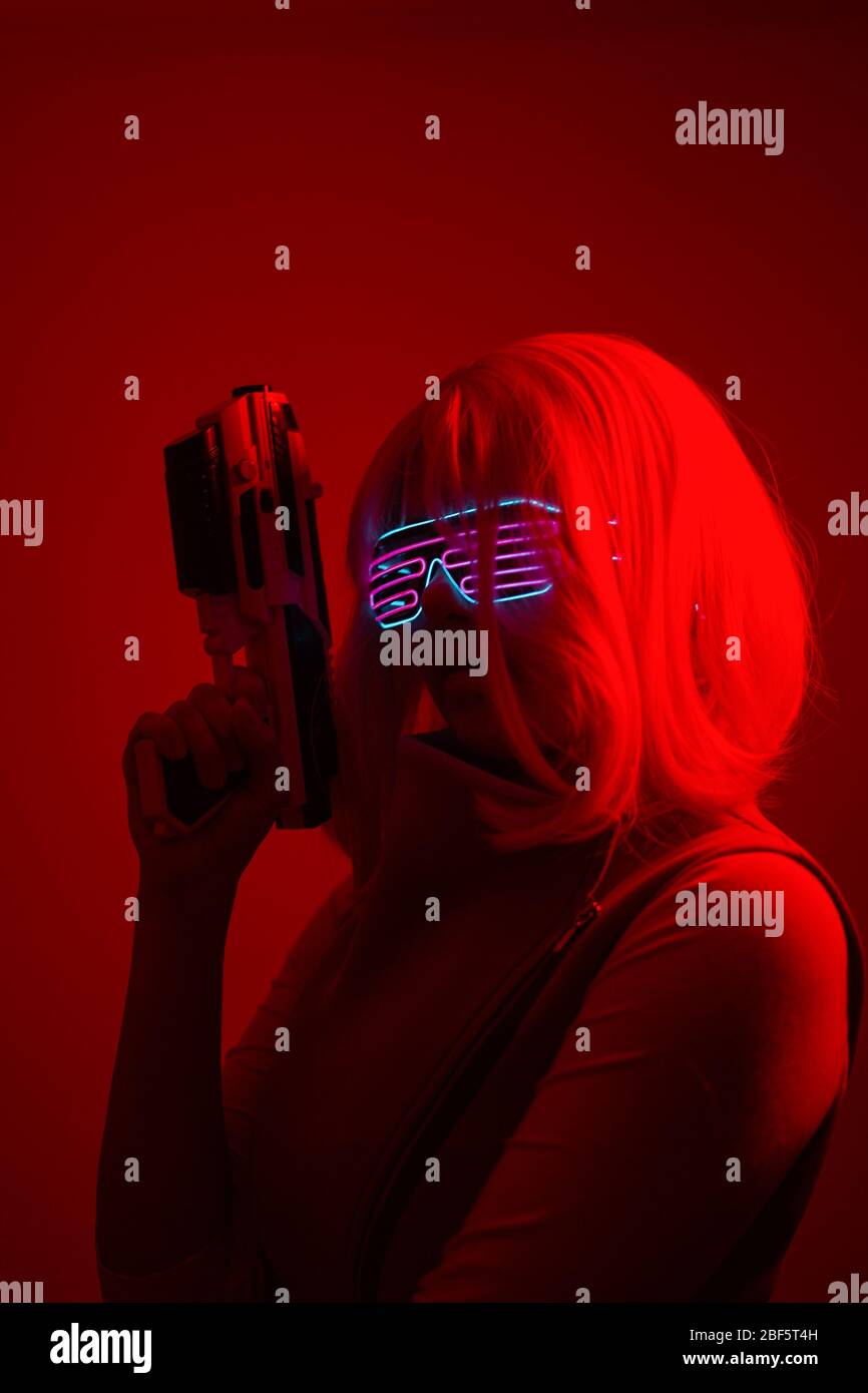 Girl with blaster in the futuristic battle. Concept virtual reality ...