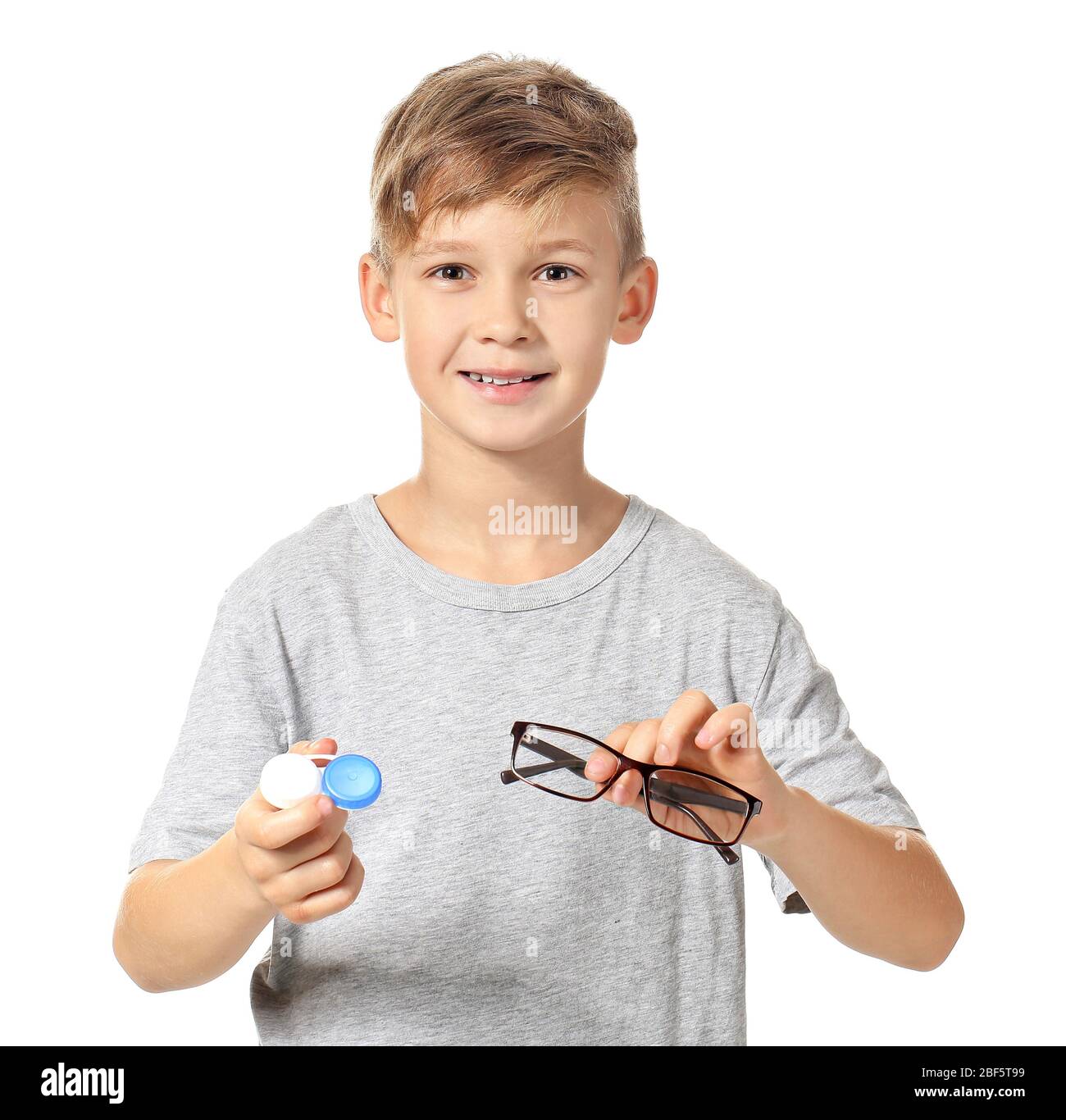 Little boy with contact lens case and eyeglasses on white background ...