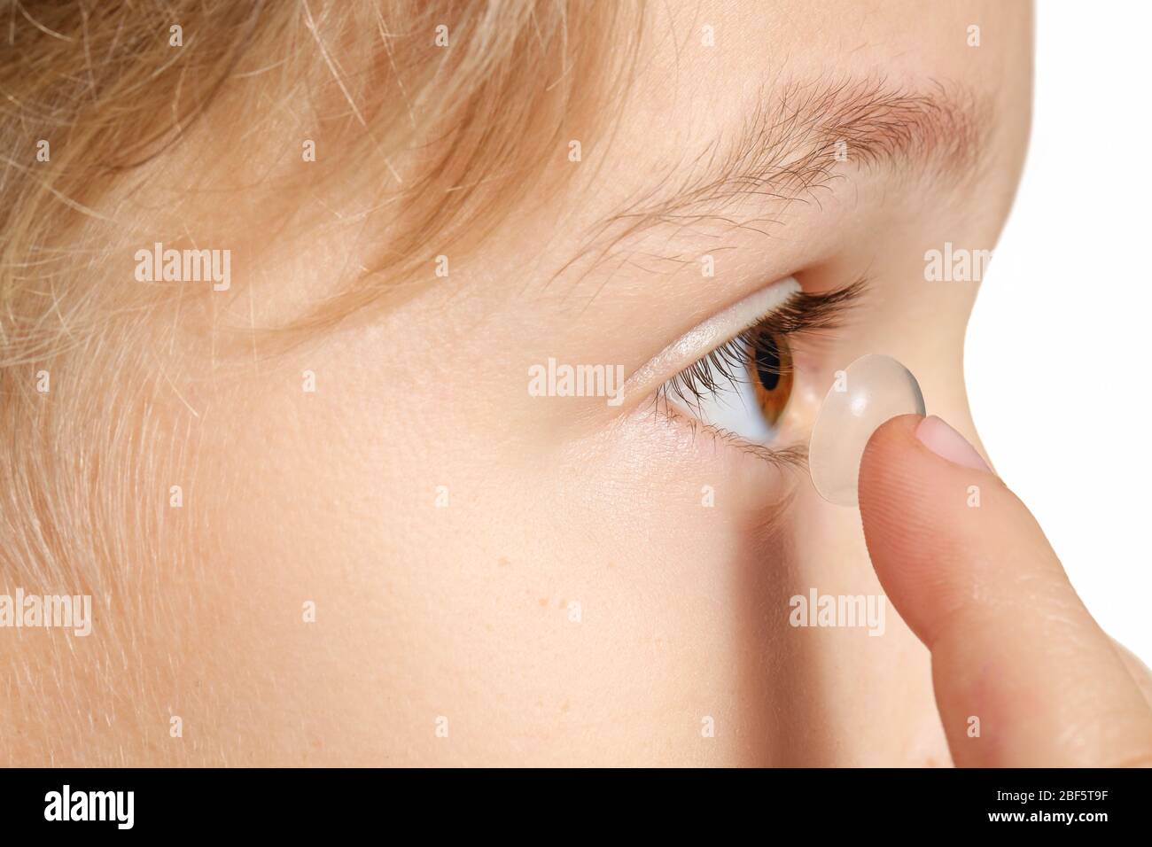 Little boy putting in contact lens, closeup Stock Photo - Alamy