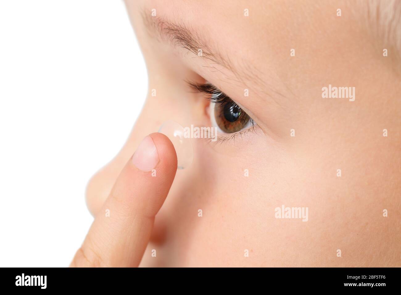 Little boy putting in contact lens, closeup Stock Photo - Alamy