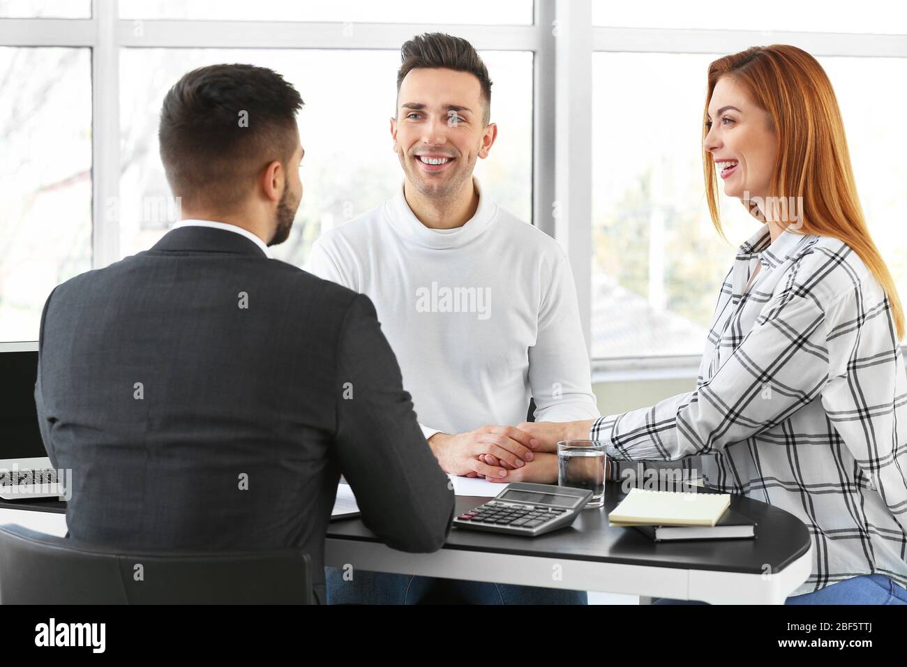 Bank manager working with clients in office Stock Photo - Alamy