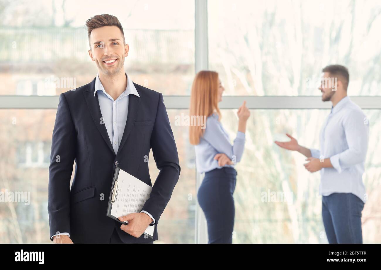 Portrait of young bank manager in office Stock Photo - Alamy