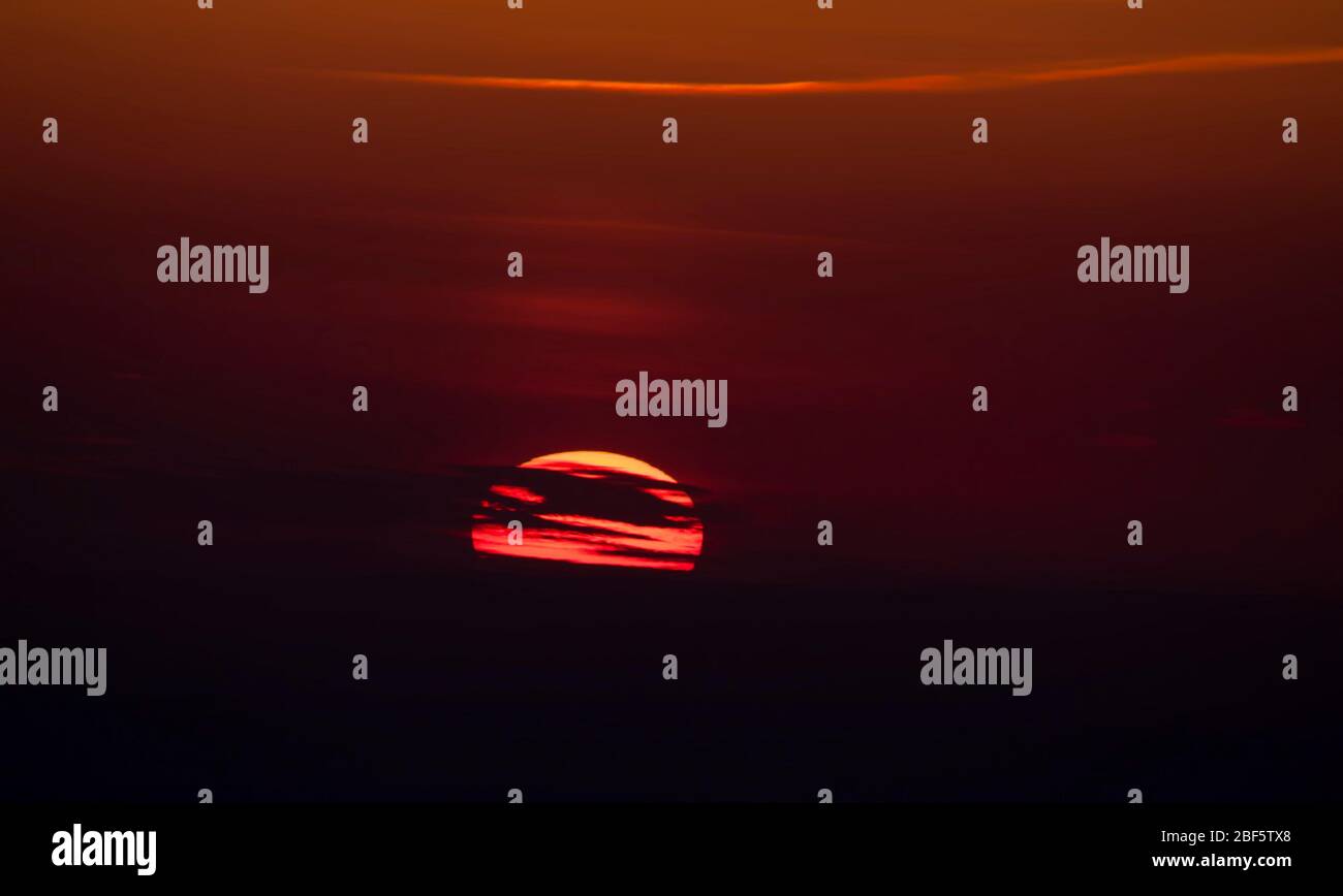 bug sun at sunset with clouds in the dark Stock Photo - Alamy