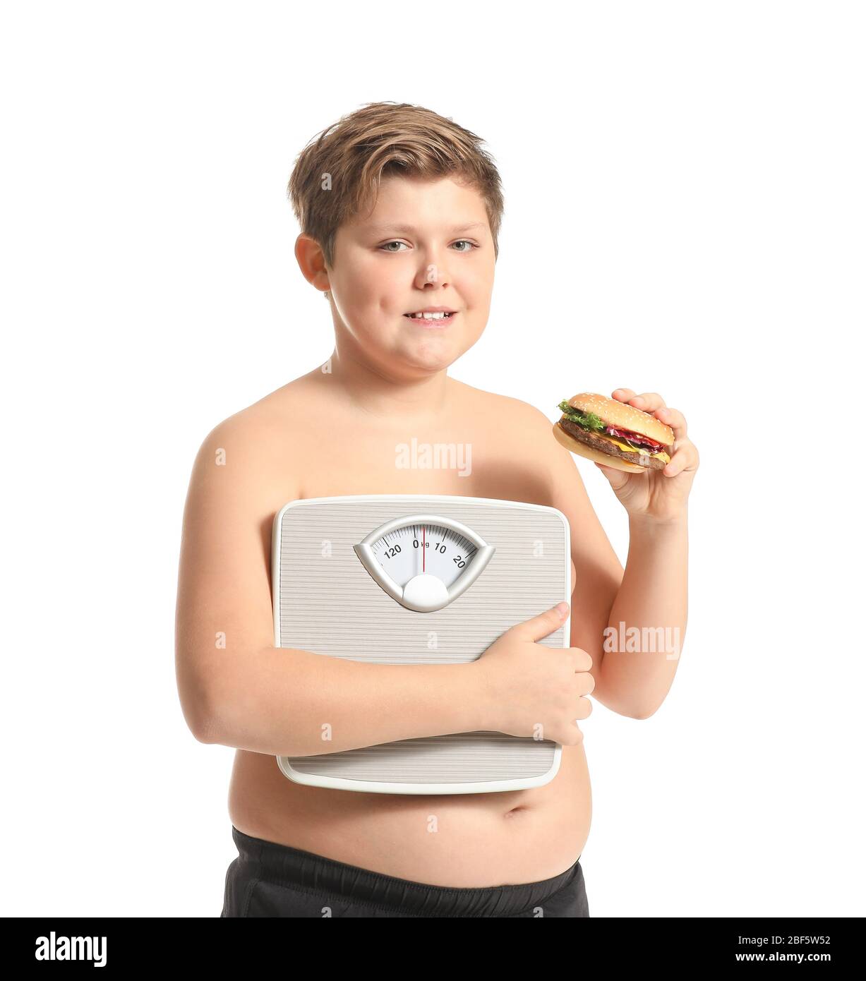 Overweight boy with burger and scales on white background Stock Photo ...