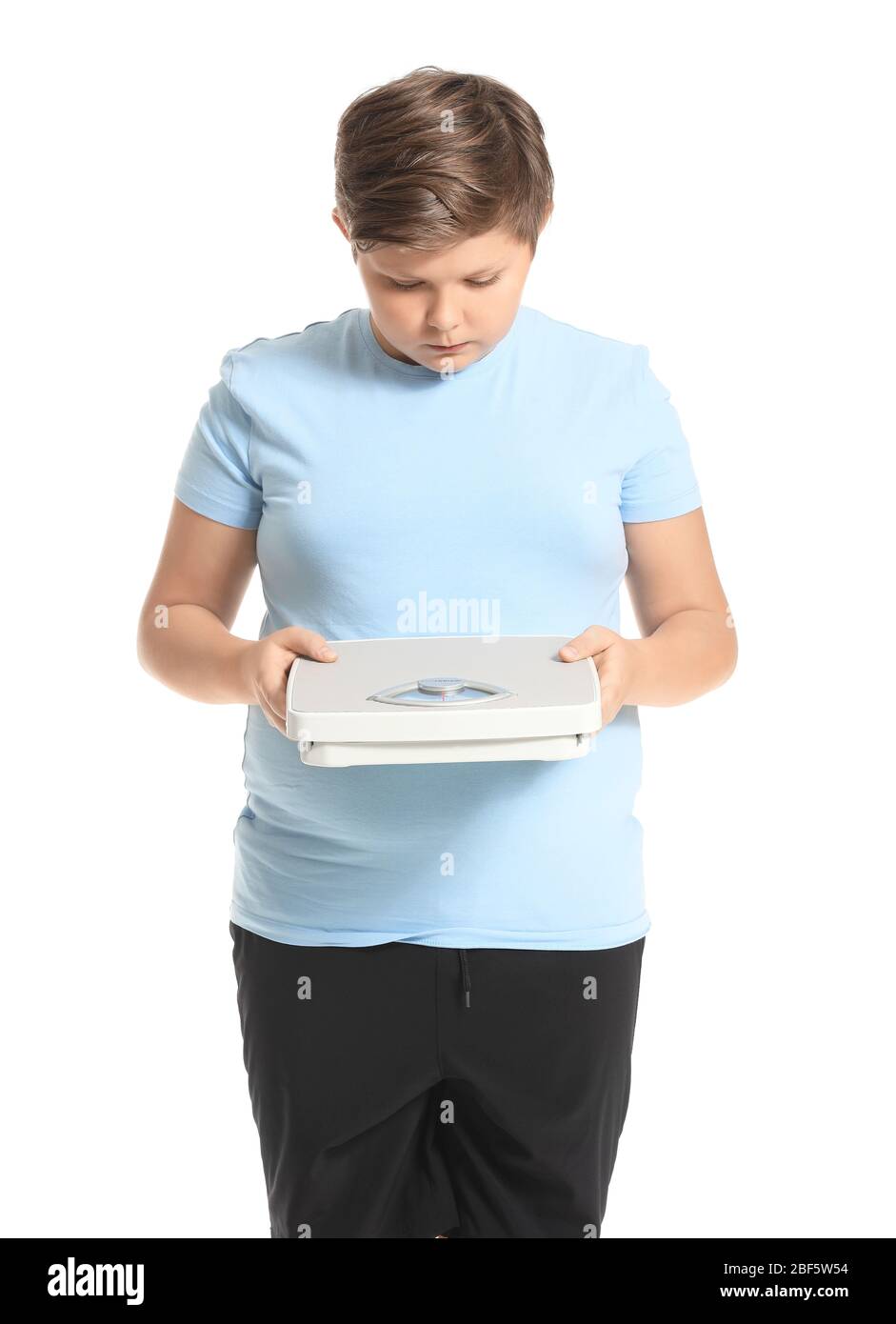 Overweight boy with scales on white background Stock Photo - Alamy