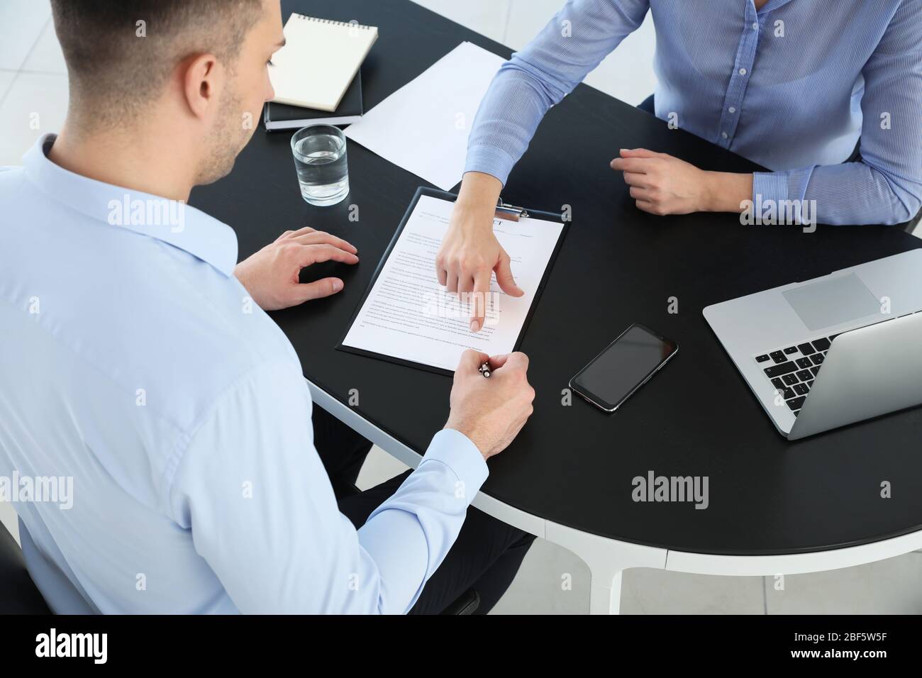 Bank manager working with man in office Stock Photo - Alamy
