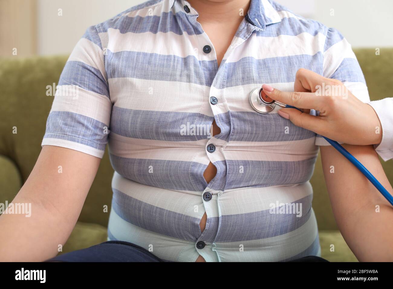 Doctor examining fat boy in clinic Stock Photo - Alamy