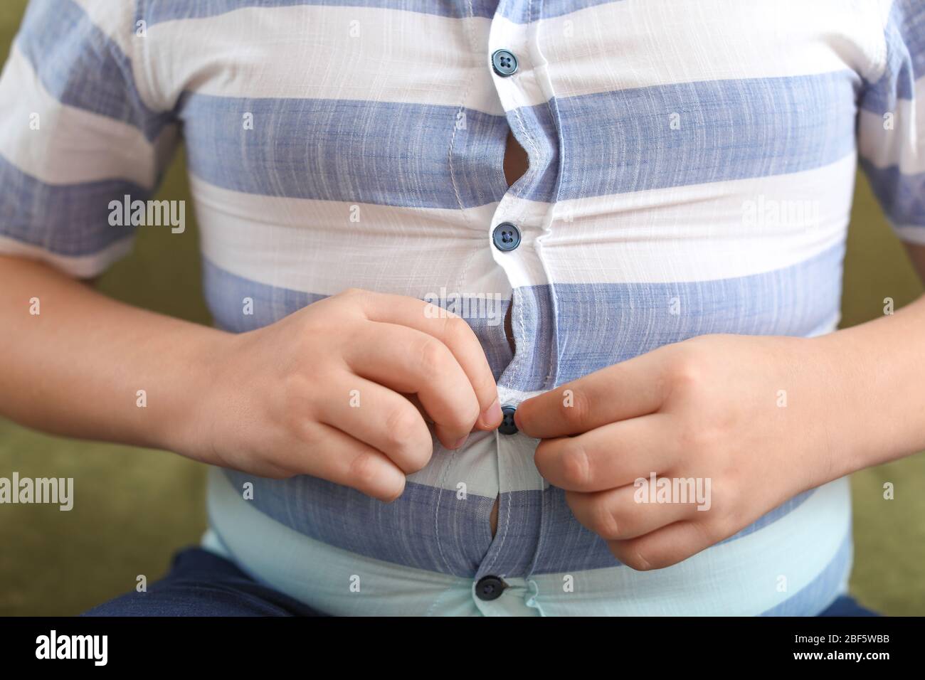 Overweight boy in tight clothes, closeup Stock Photo - Alamy