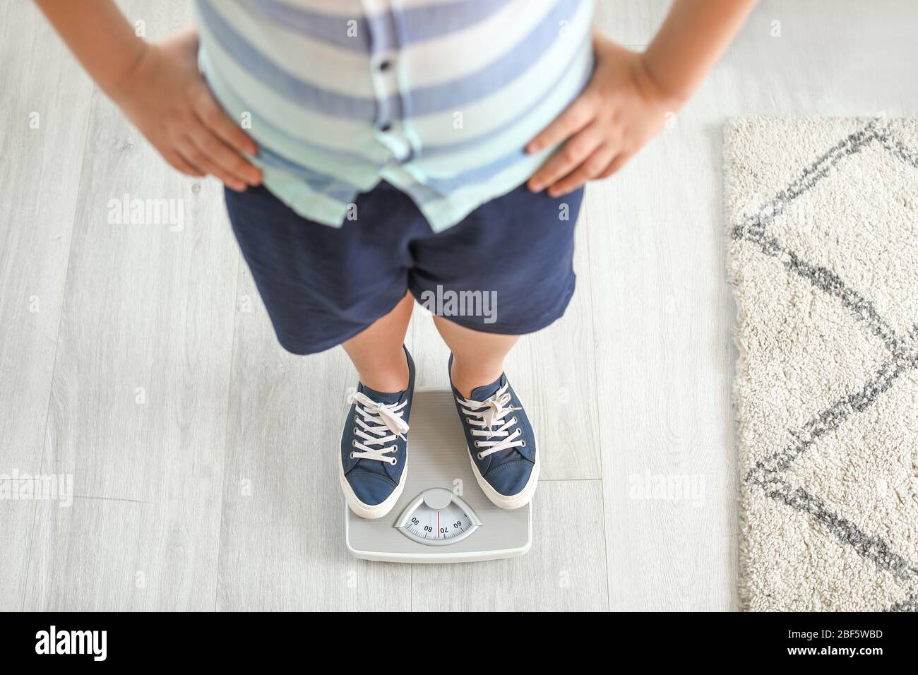 Overweight child scales hi-res stock photography and images - Alamy