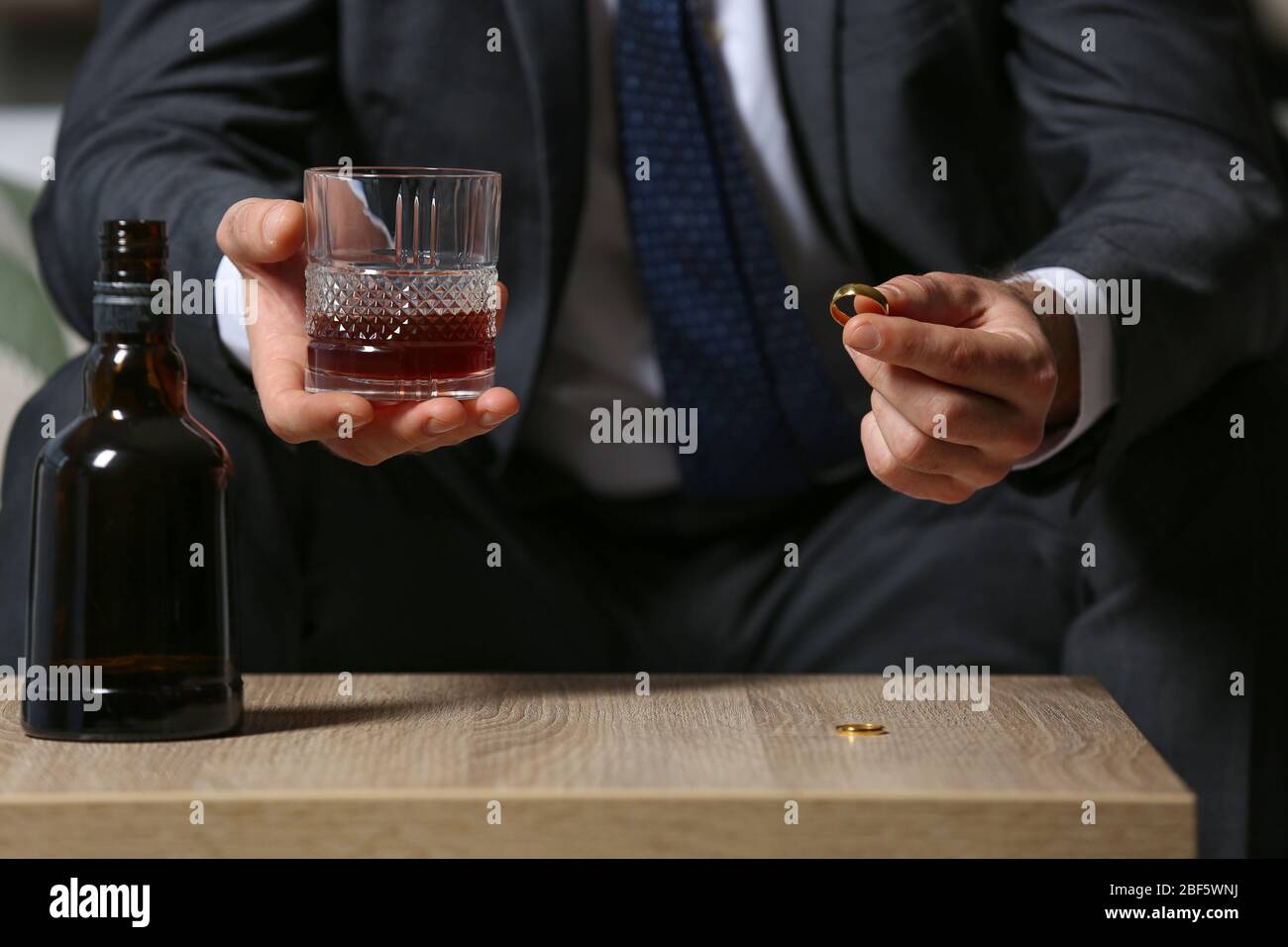 Divorced man drinking cognac at home. Concept of alcoholism Stock Photo ...