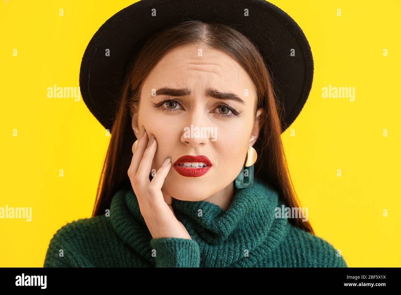 Sad young woman on color background Stock Photo - Alamy