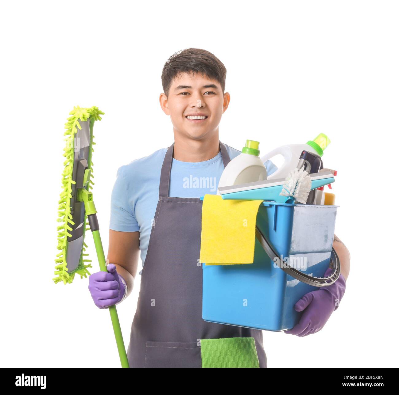 Asian janitor with cleaning supplies on white background Stock Photo ...