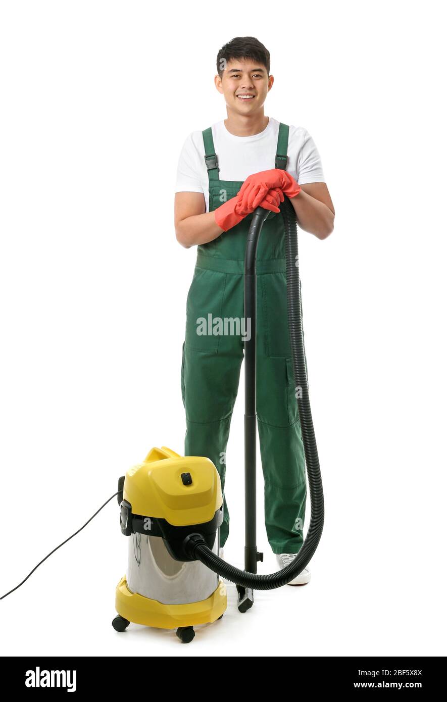 Asian janitor with vacuum cleaner on white background Stock Photo - Alamy