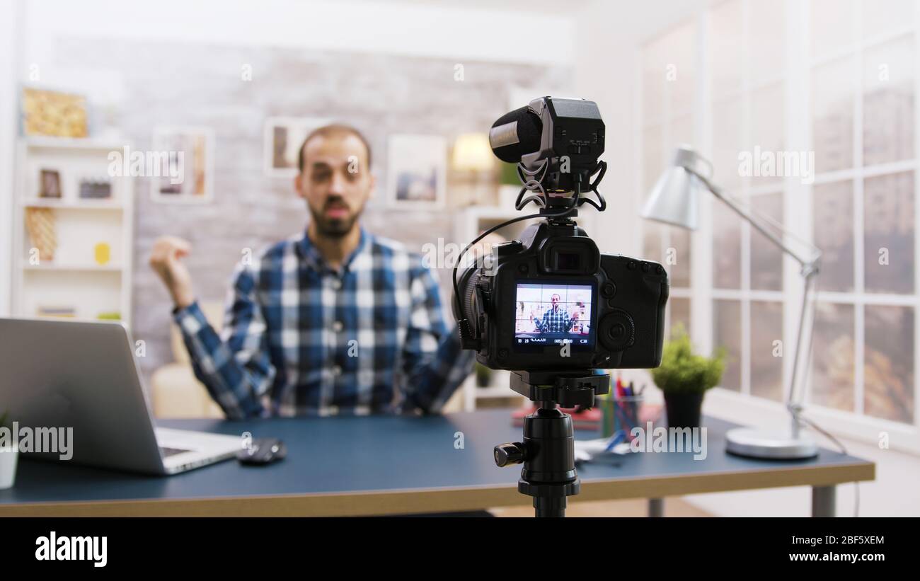 Young and cheerful vlogger recording for subscribers. Famous influencer ...