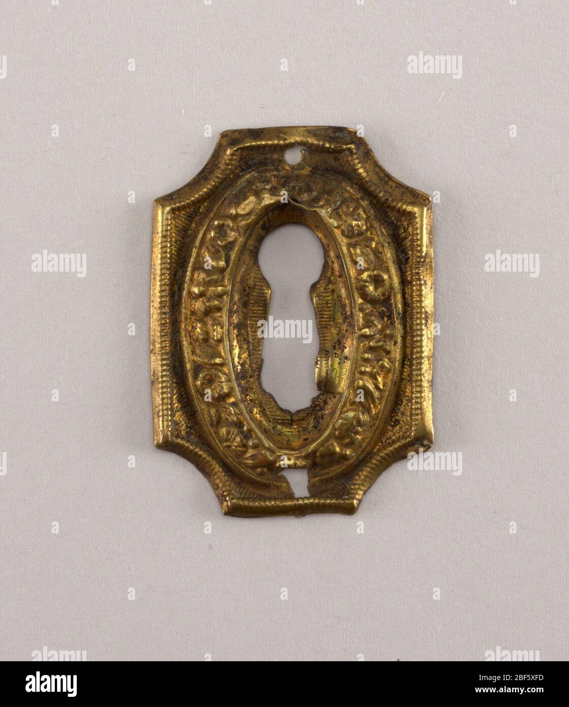 Keyhole escutcheon. Rectangular, with concave circular corners; shaped ...