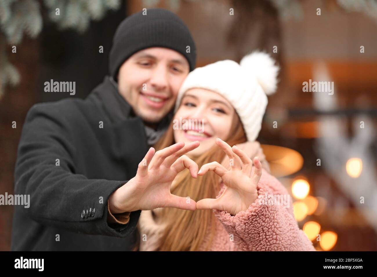 Happy young couple making heart shape with their hands outdoors Stock ...