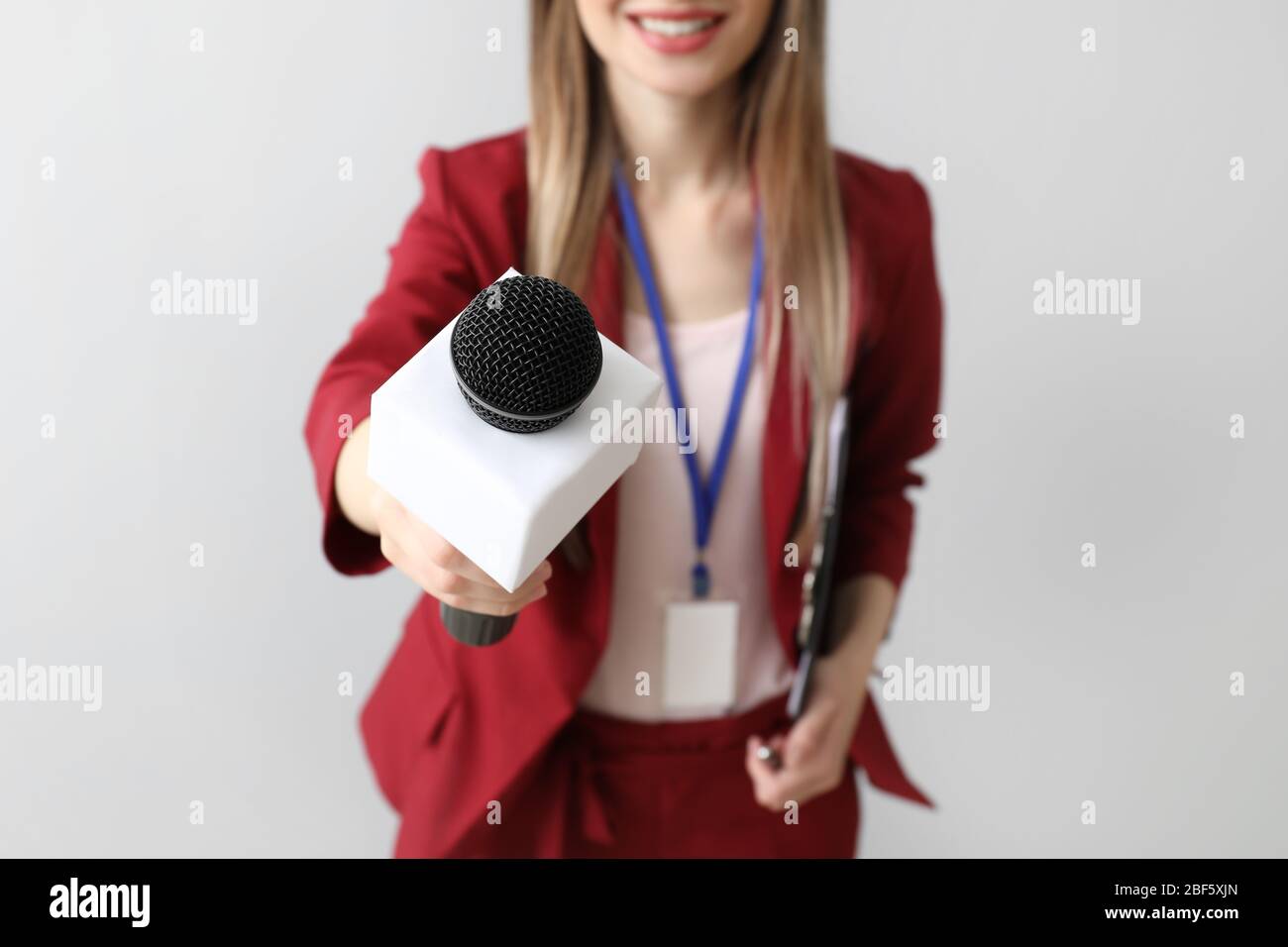 Female journalist on light background Stock Photo - Alamy