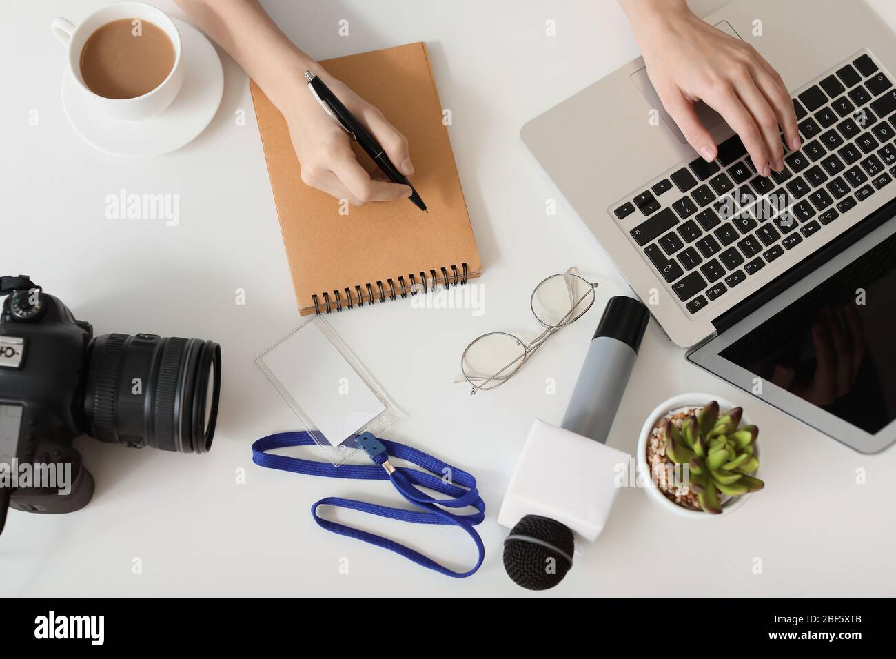 Female journalist working in office Stock Photo - Alamy